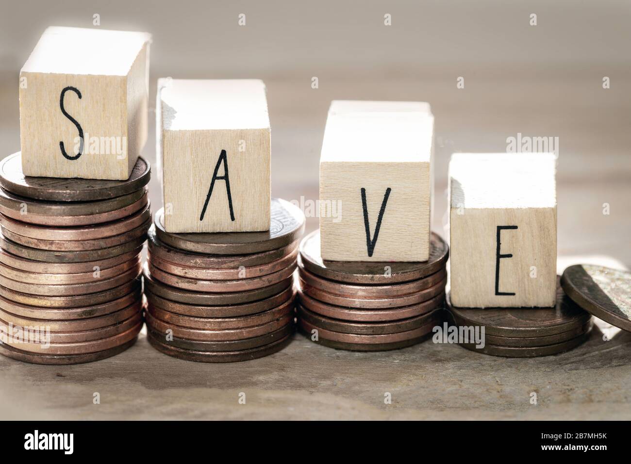 Stack of coins with save letter in wooden block, Time to Saving Concept ...