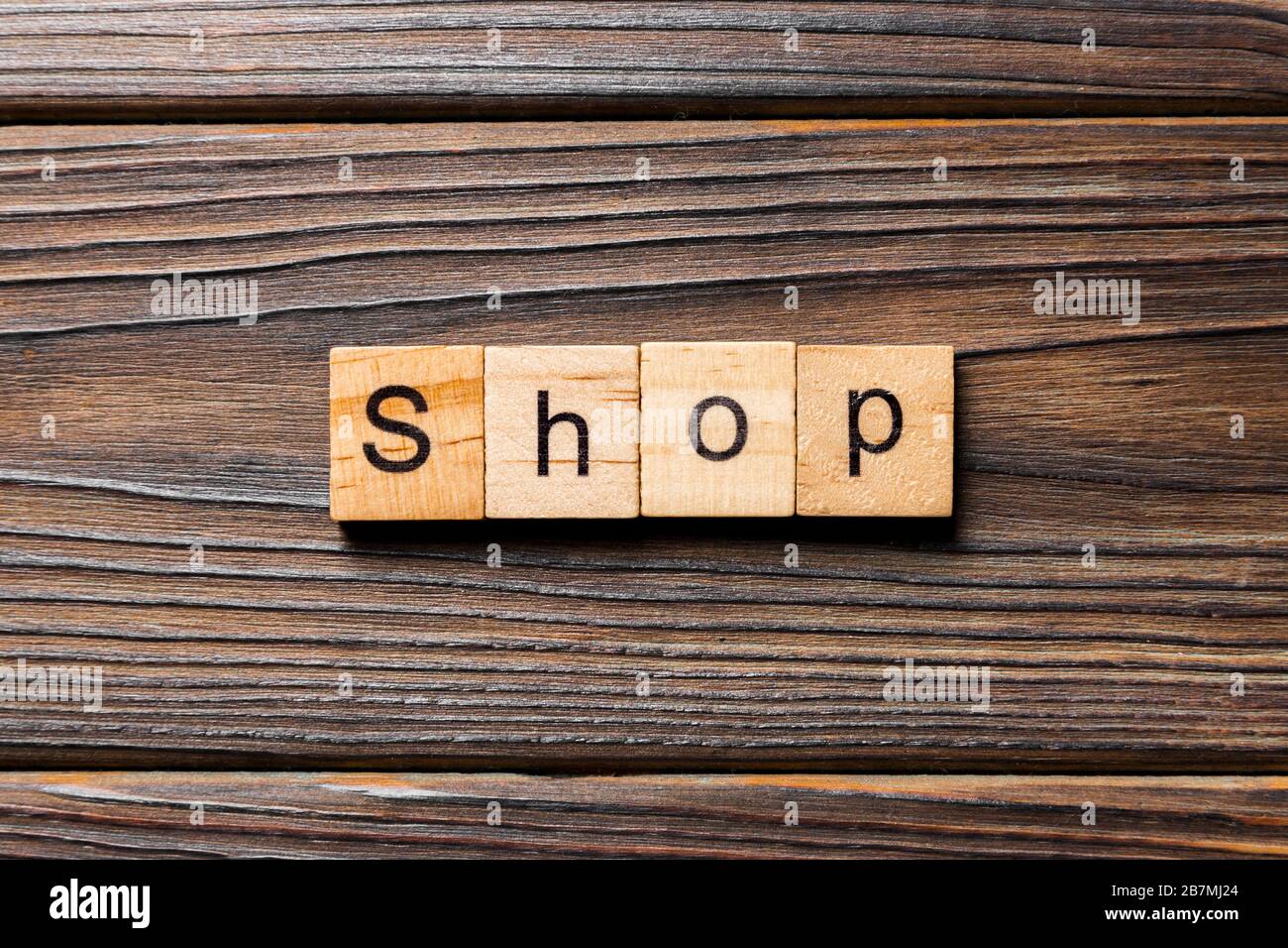 shop word written on wood block. shop text on wooden table for your ...
