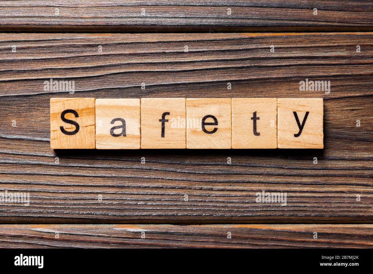safety word written on wood block. safety text on wooden table for your ...