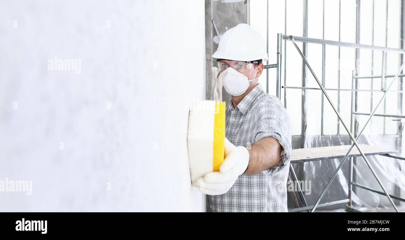 man builder using a sponge on wall professional construction worker ...