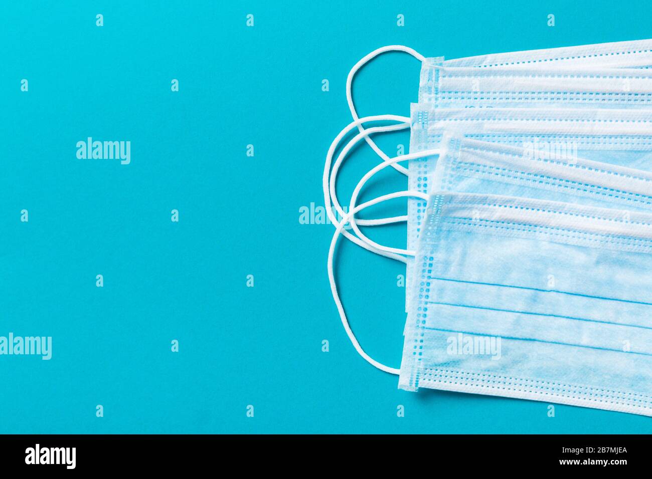 Top view of blue background with protective medical masks. Respiratory ...