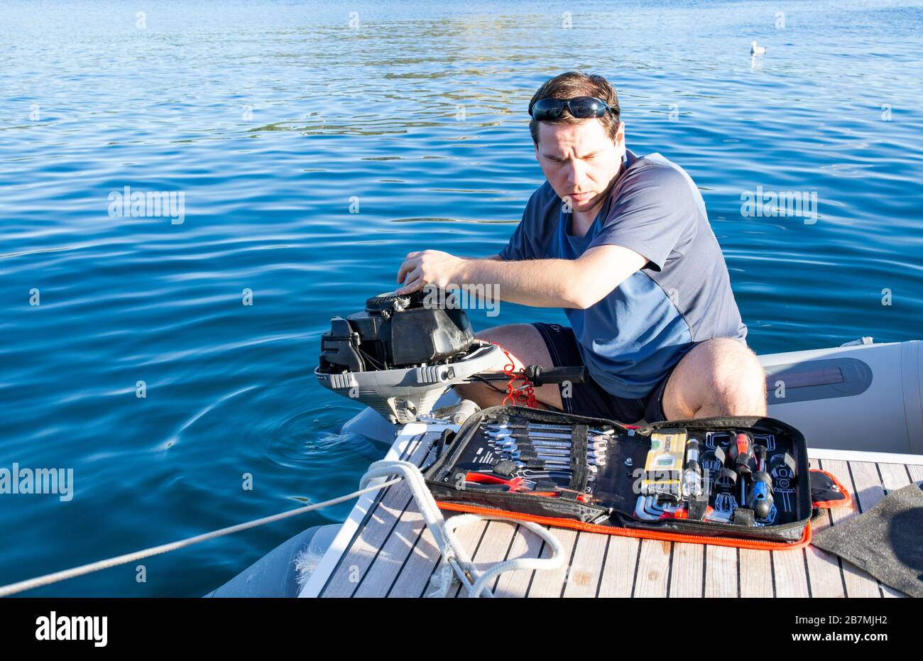 Sicily / Italy - Sailor repairing engine, dinghy boat Stock Photo - Alamy