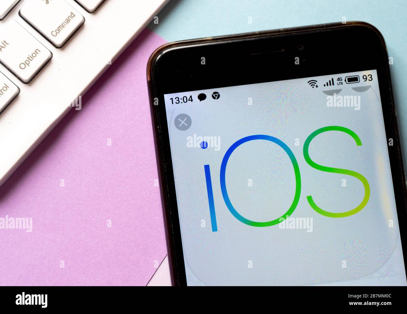 In this photo illustration iOS logo is seen displayed on a smartphone ...