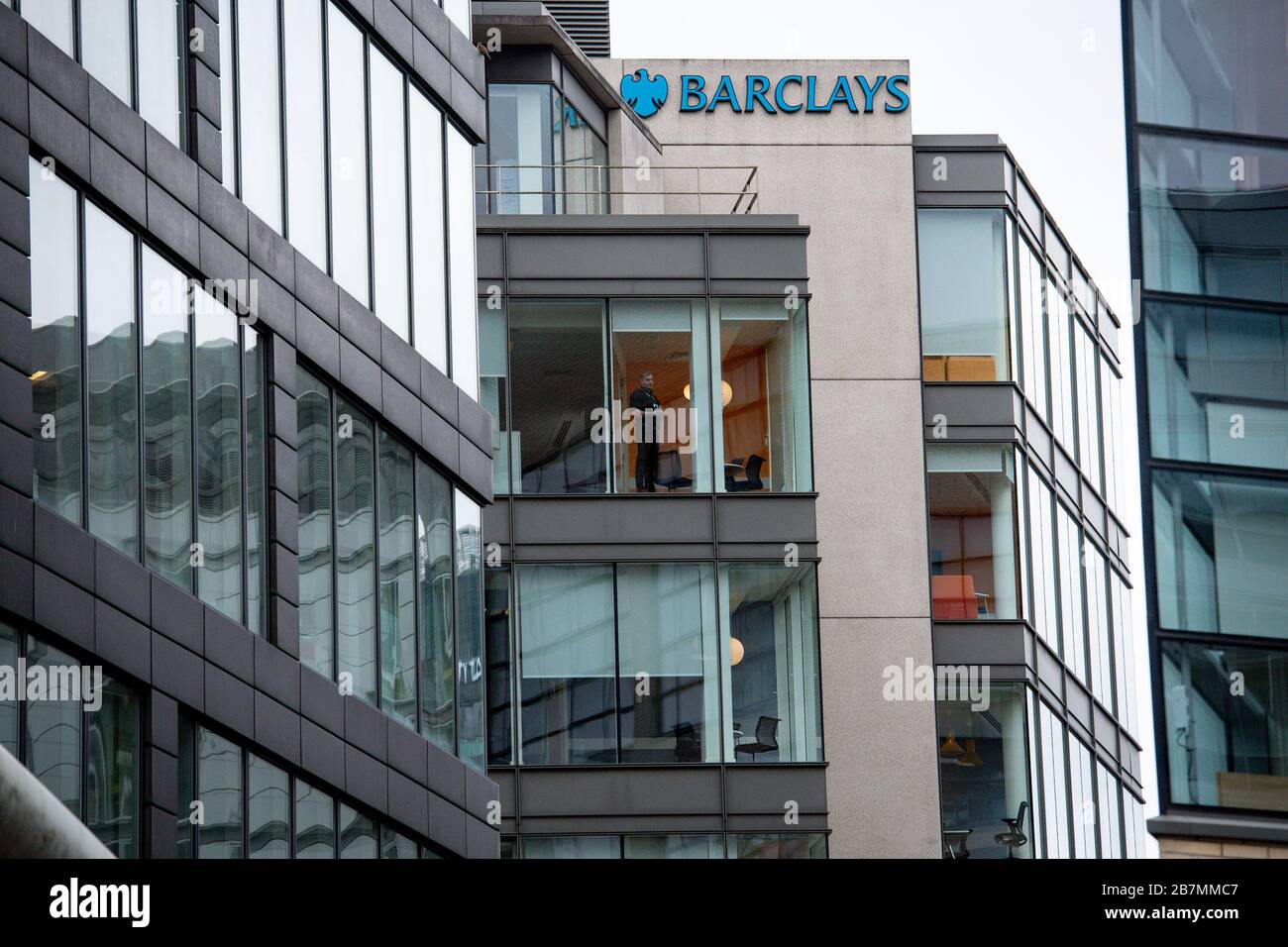 Man looks out of window at barclays office in manchester hi-res stock ...