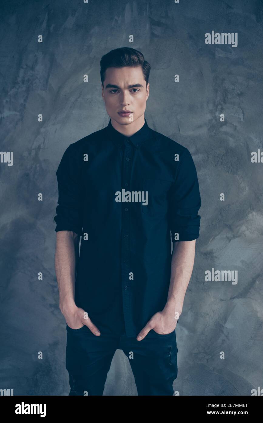 Portrait of young very handsome guy in black outfit looking straight in ...