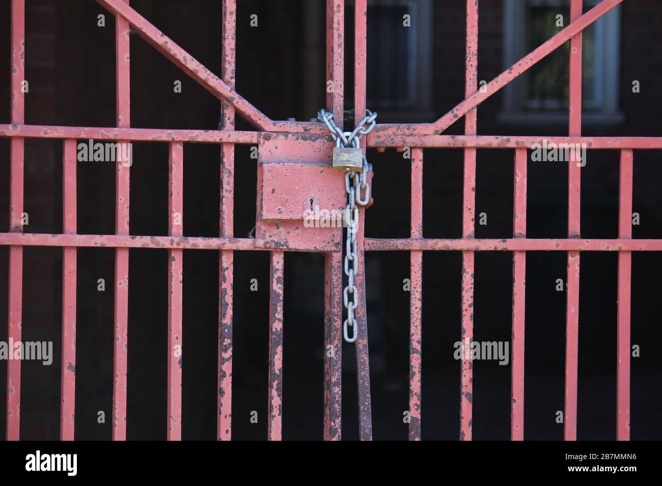 Red iron gate secured by chain and padlock Narrogin, Western Australia ...