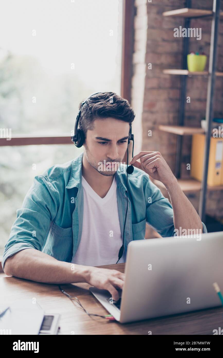 Vertical portrait of operator of call center receiving a call from a ...