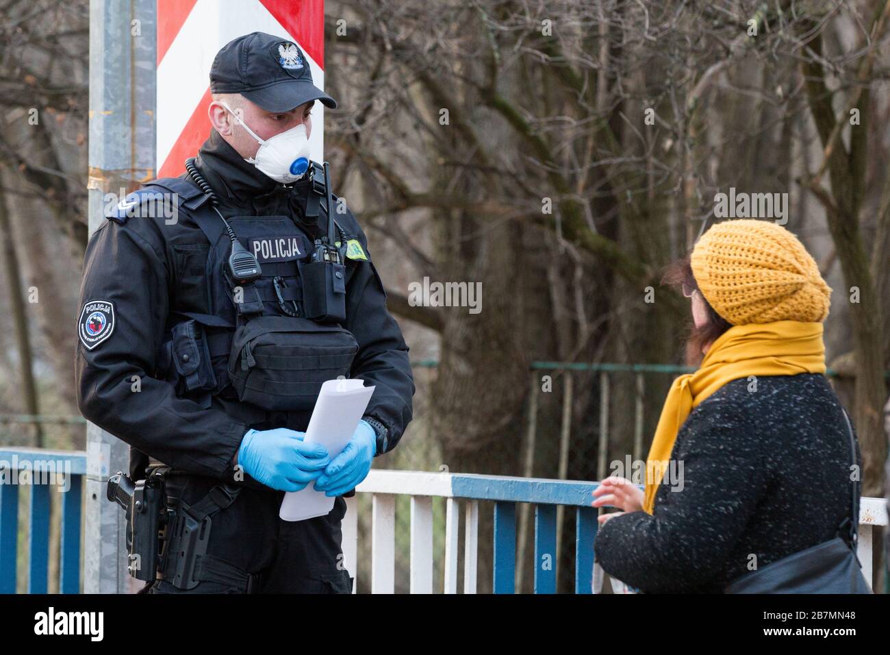 A policeman wears a protective mask on the German-Polish border at the ...