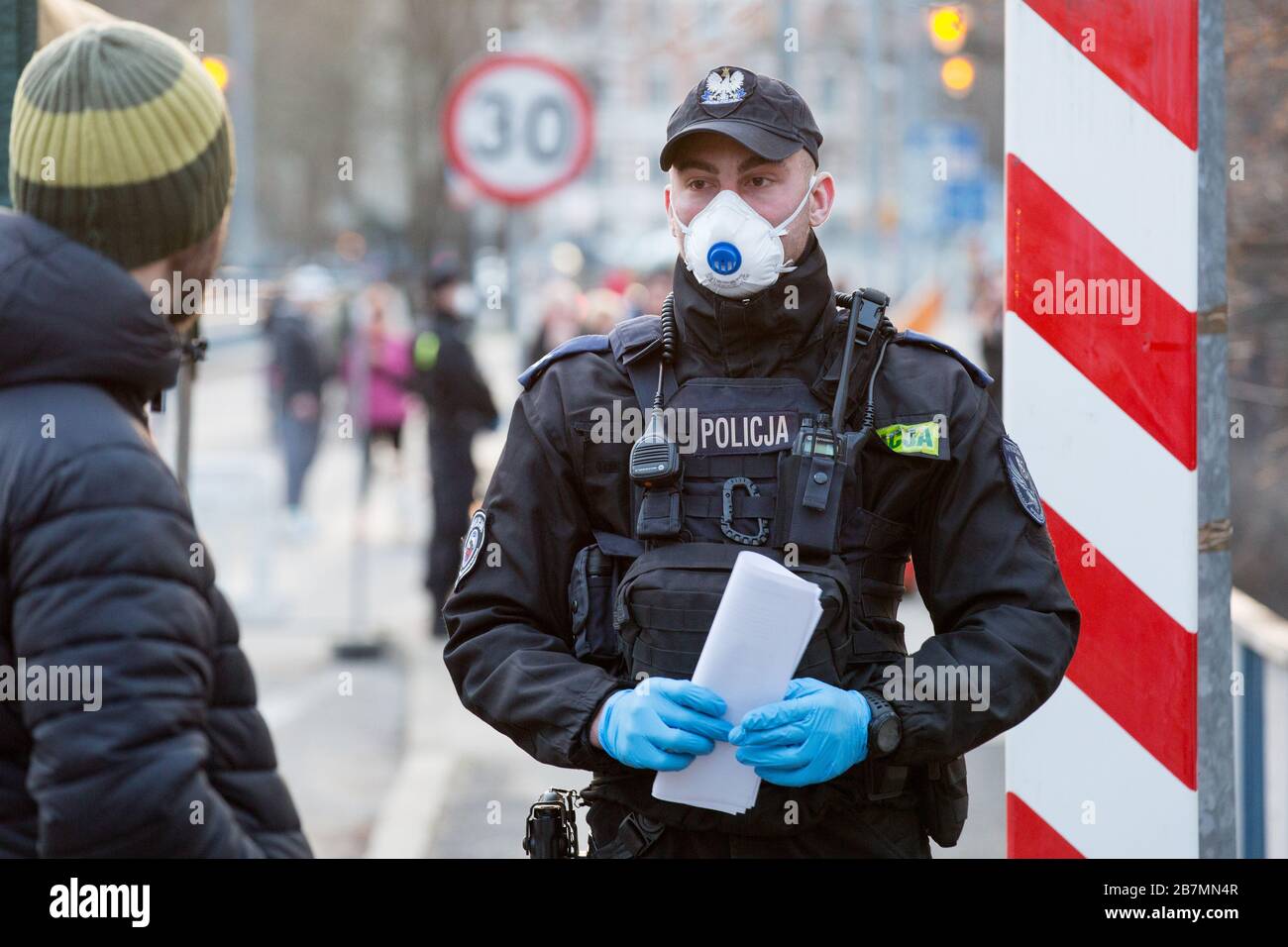 A policeman wears a protective mask on the German-Polish border at the ...