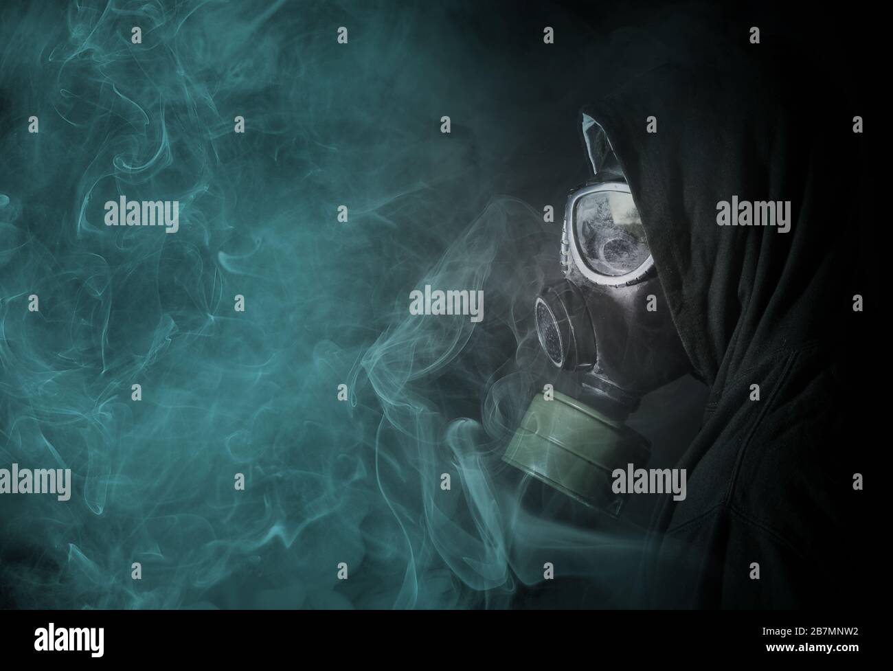 Man in a gas mask in the toxic smoke, blue smoke Stock Photo - Alamy
