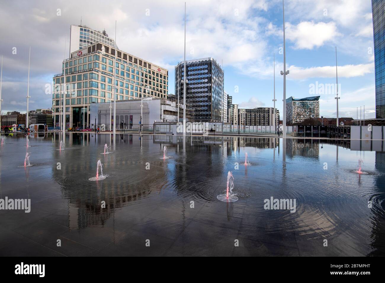 Construction projects reflected in a water feature in Centenary Square ...