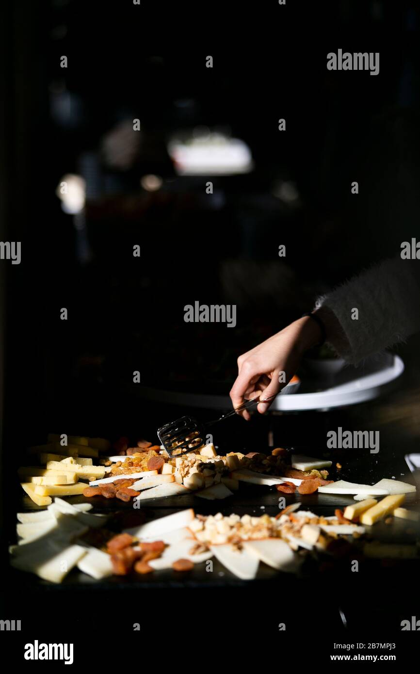 Hands taking cheese from a food station during an event Stock Photo - Alamy