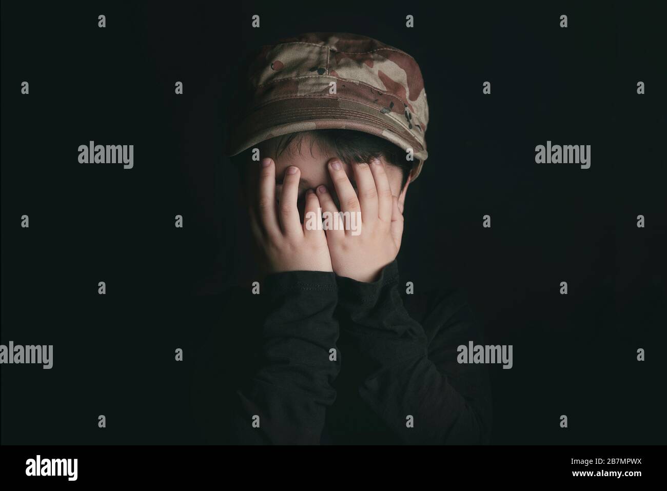 Scared boy on black background Stock Photo - Alamy