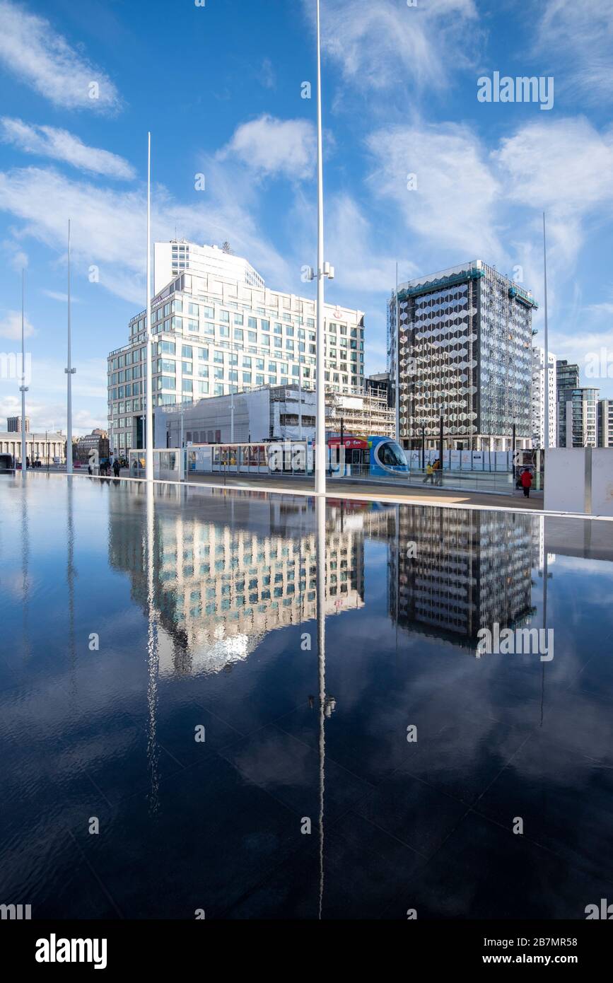 Construction projects reflected in a water feature in Centenary Square ...