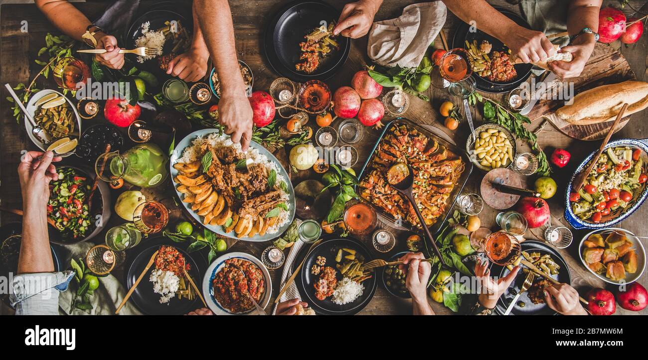 Flat-lay of family feasting with Turkish cuisine foods, wide ...