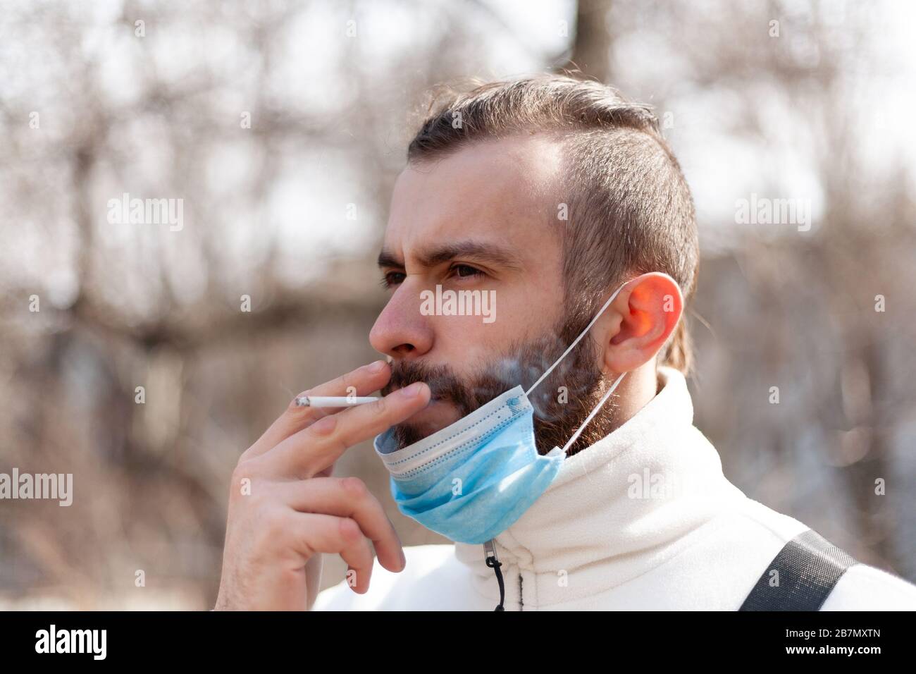Guy smokes cigarette on street hi-res stock photography and images - Alamy