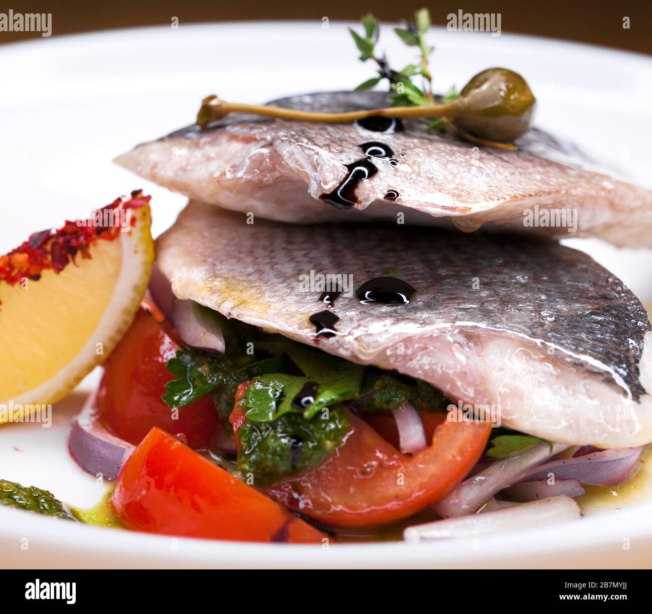 Restaurant food - Grilled Dorado fish with onion and lemon slice on ...
