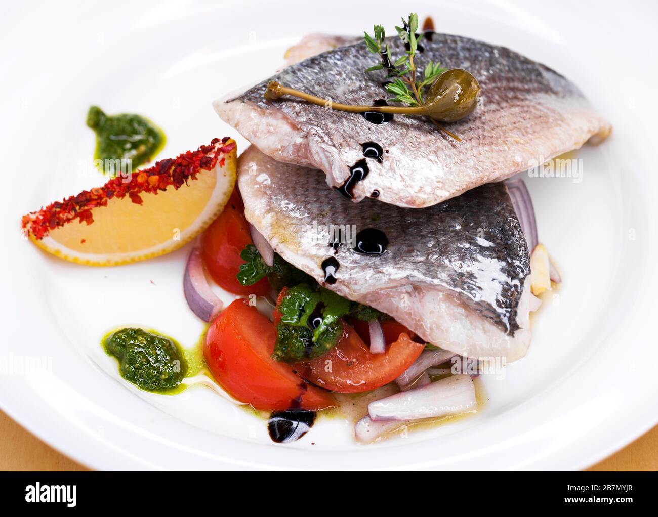Restaurant food - Grilled Dorado fish with onion and lemon slice on ...