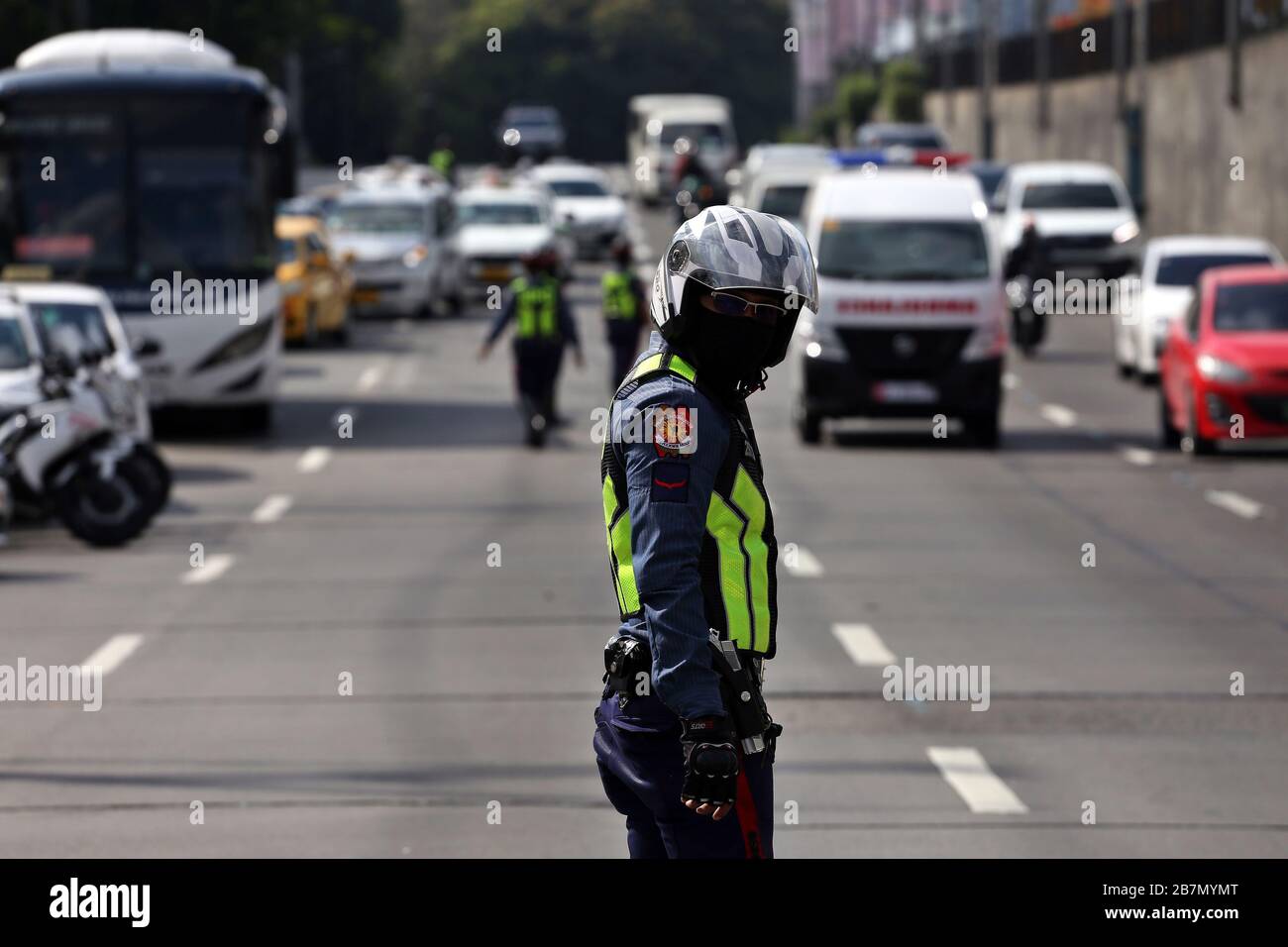 Manila, Philippines. 17th Mar, 2020. A police officer is standing at a ...