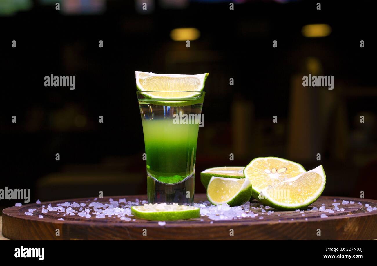 Alcohol cocktail with tequila and a slice of lime Stock Photo - Alamy