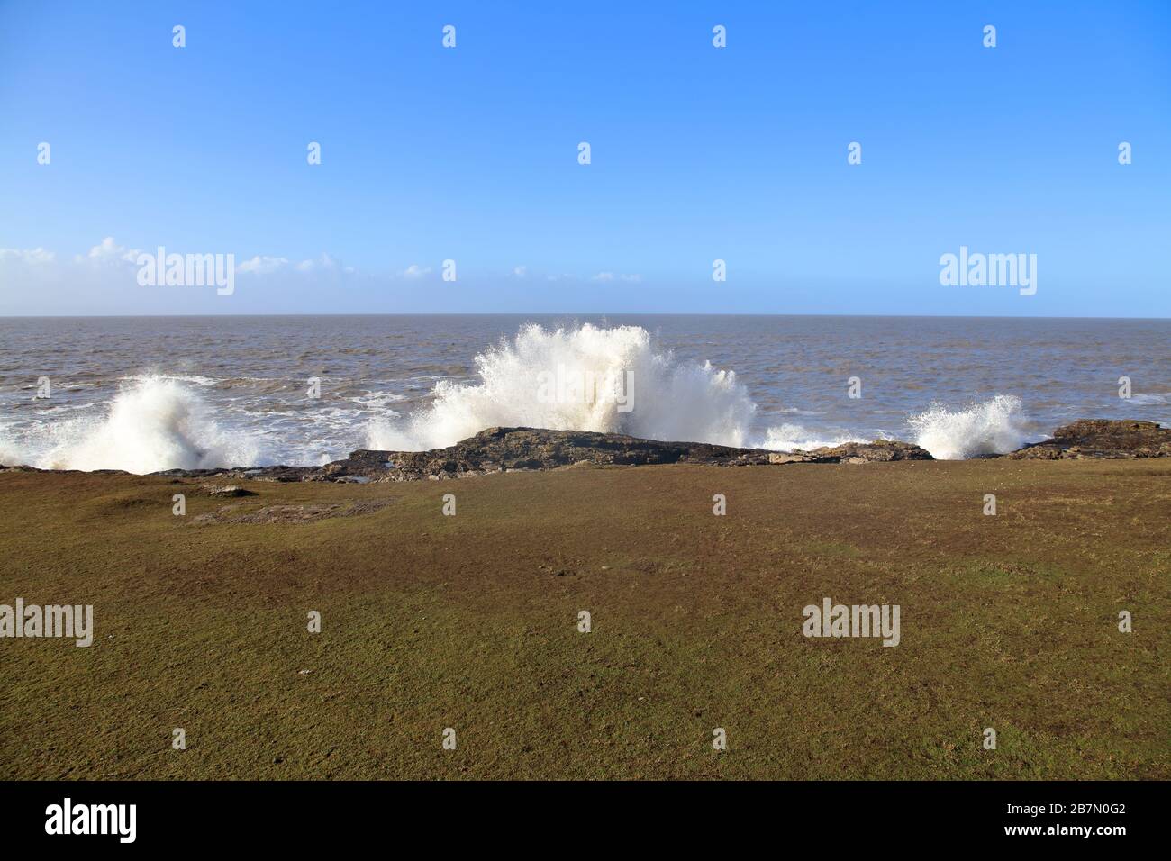 Large waves battering into the shore cliffs at Ogmore by sea in ...
