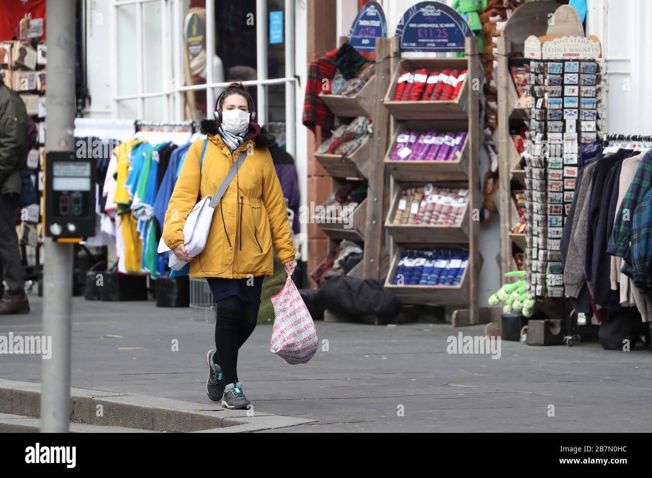 A woman wearing a face mask in edinburgh hi-res stock photography and ...