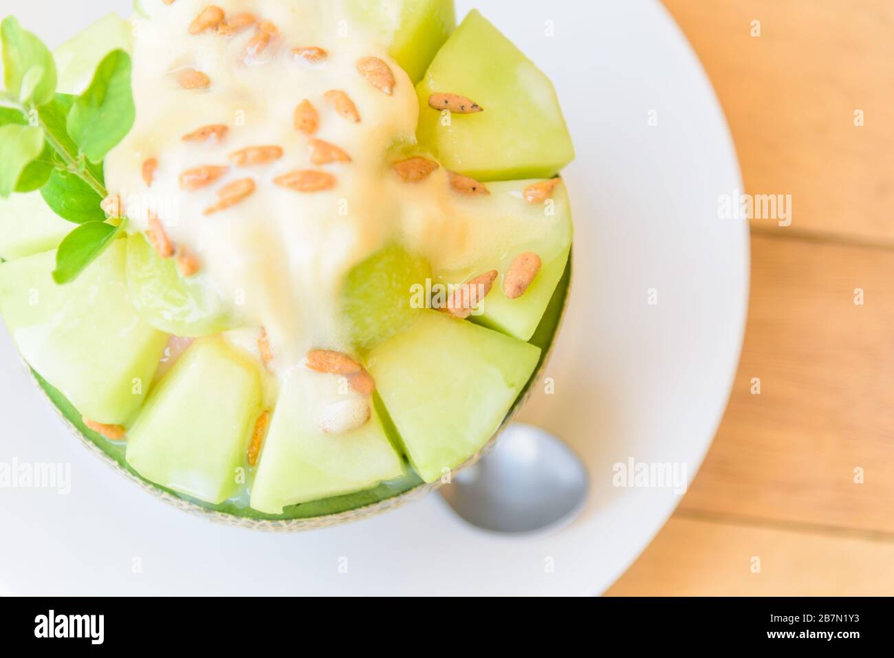 Melon Bingsu with Sweetened Condensed Milk on wood table Stock Photo ...