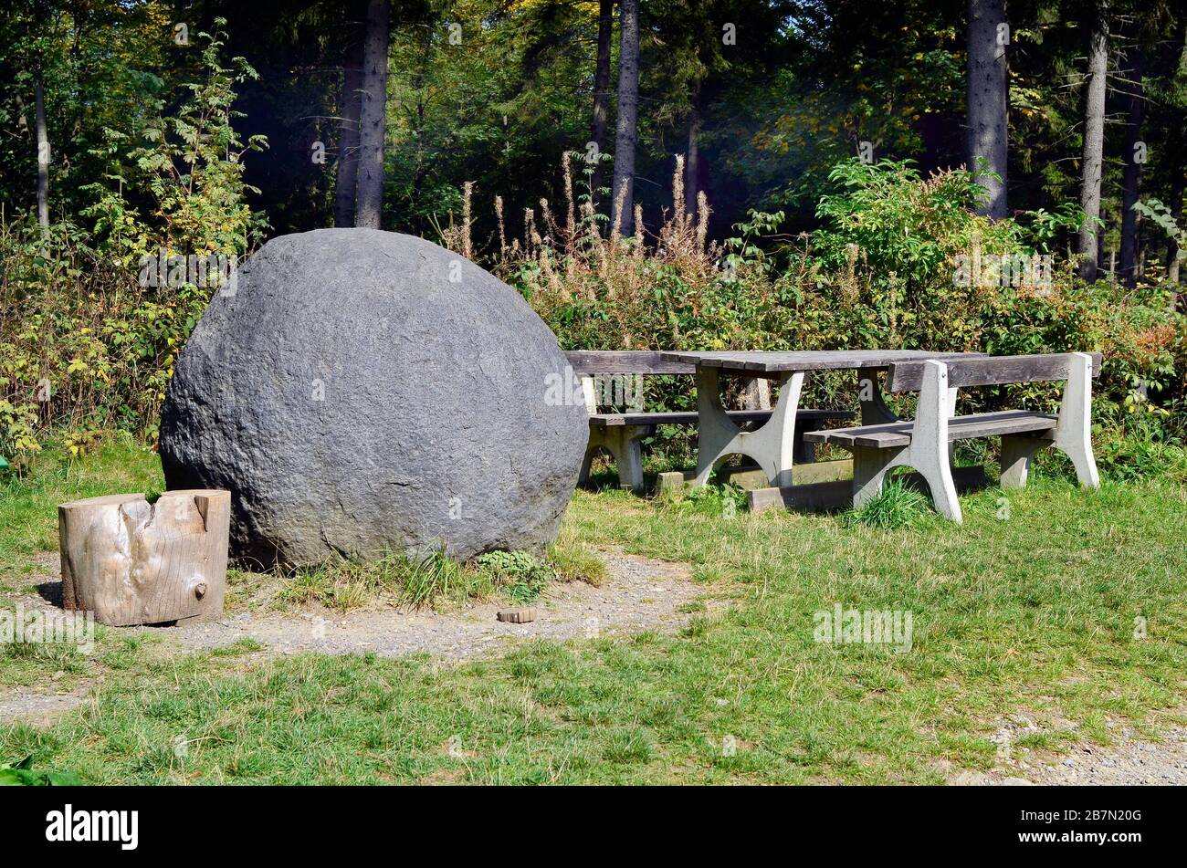 Austria, bench on resting place and circular boulder in ...