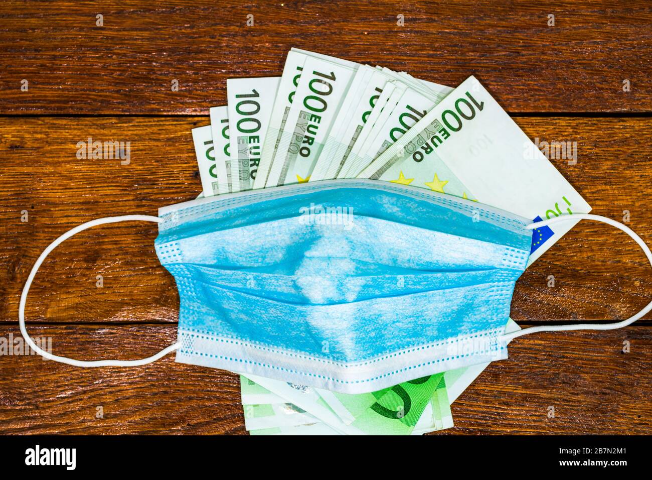 Money with surgical mask on wooden table. Flu disease virus spreading ...