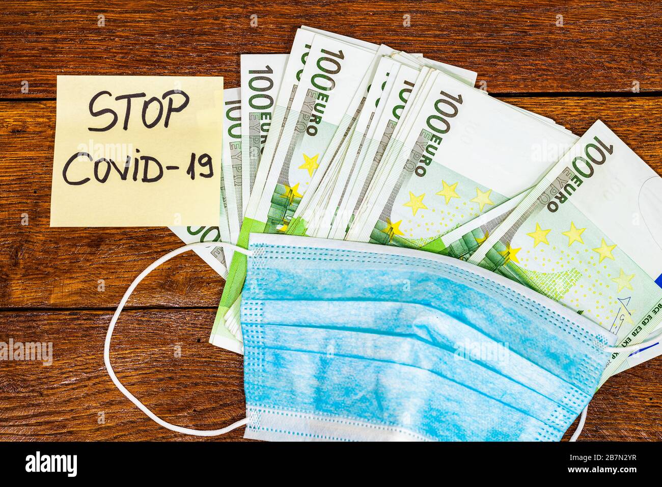 Money with surgical mask on wooden table. Flu disease virus spreading ...