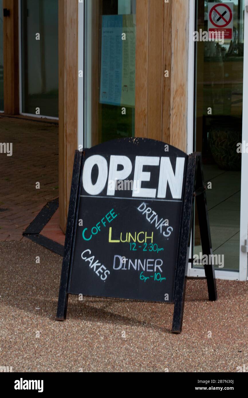 a cafe sign saying open for cakes, coffee ,lunch and drinks Stock Photo ...