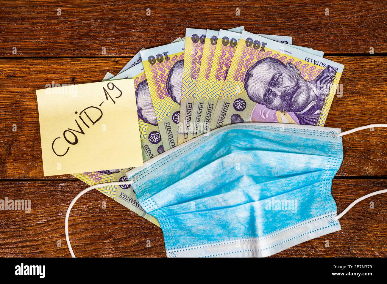 Money with surgical mask on wooden table. Flu disease virus spreading ...