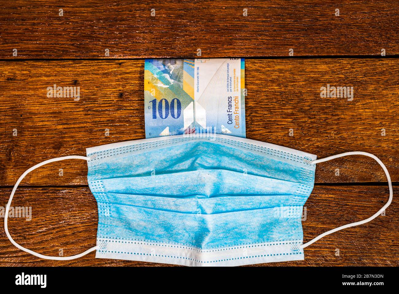 Money with surgical mask on wooden table. Flu disease virus spreading ...