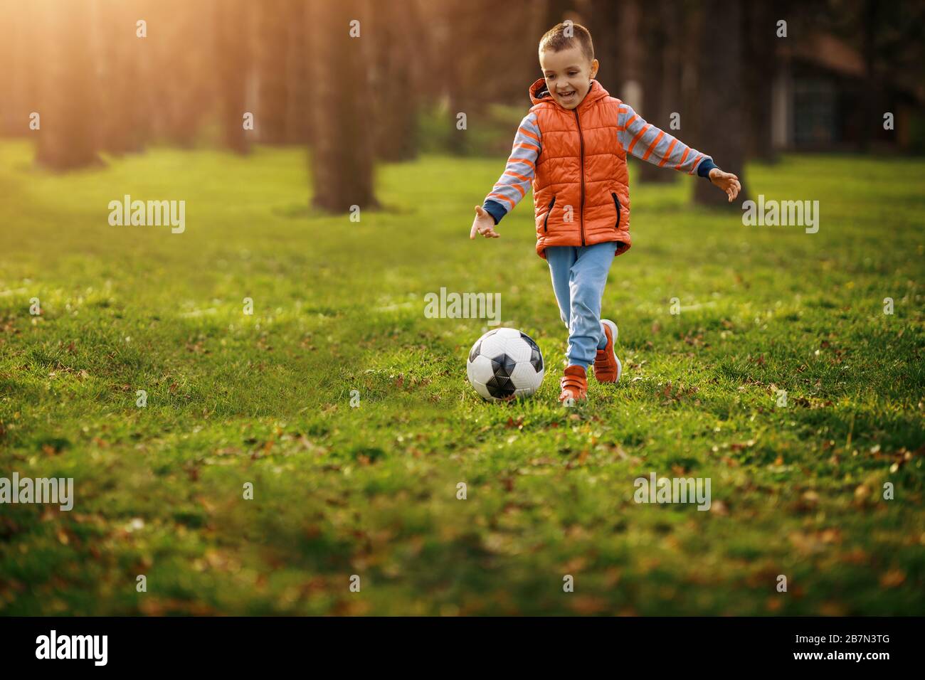 Boy kicking football hi-res stock photography and images - Alamy