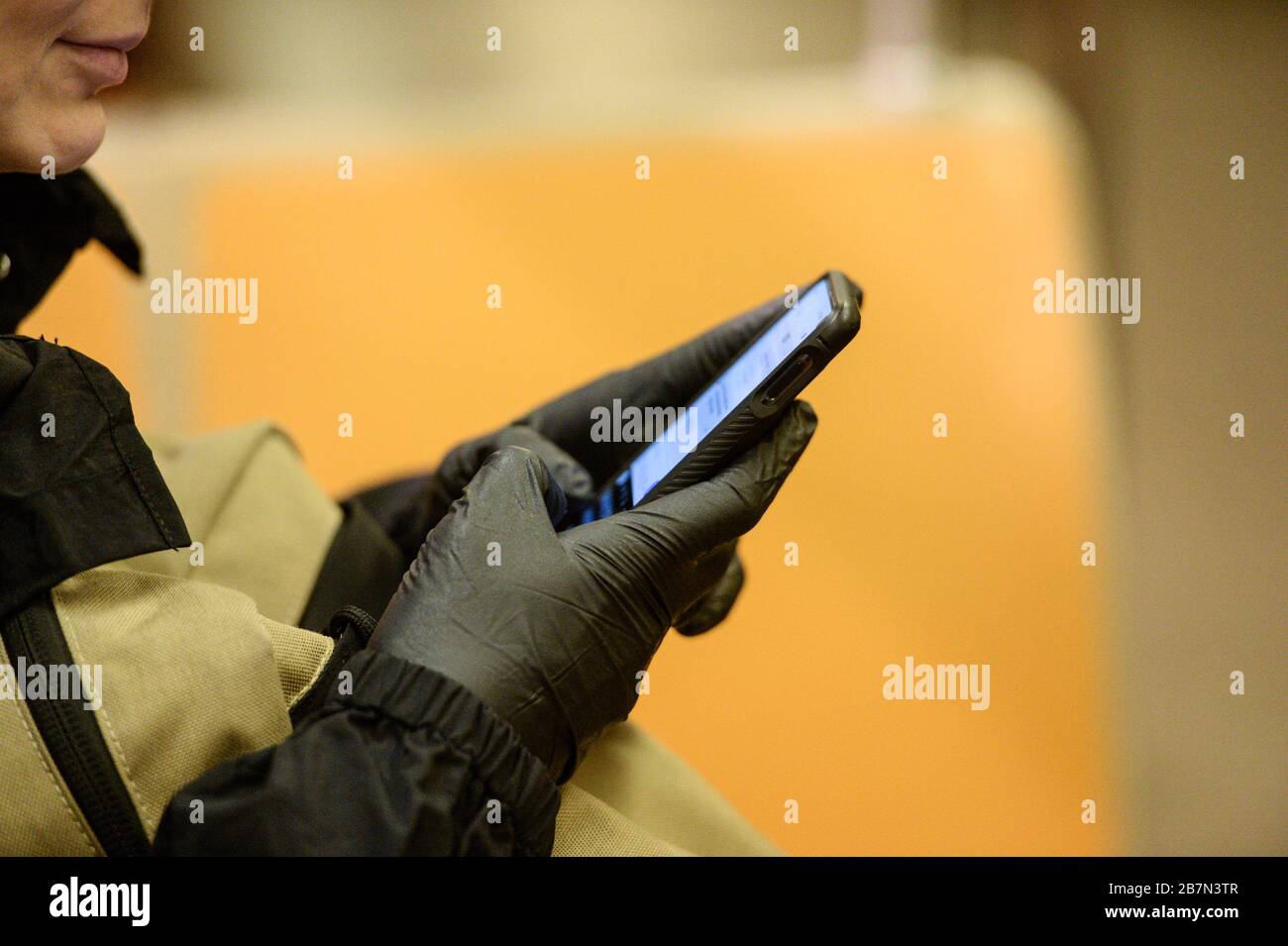 New York Manhattan, USA. 17th Mar, 2020. Commuter using surgical gloves ...