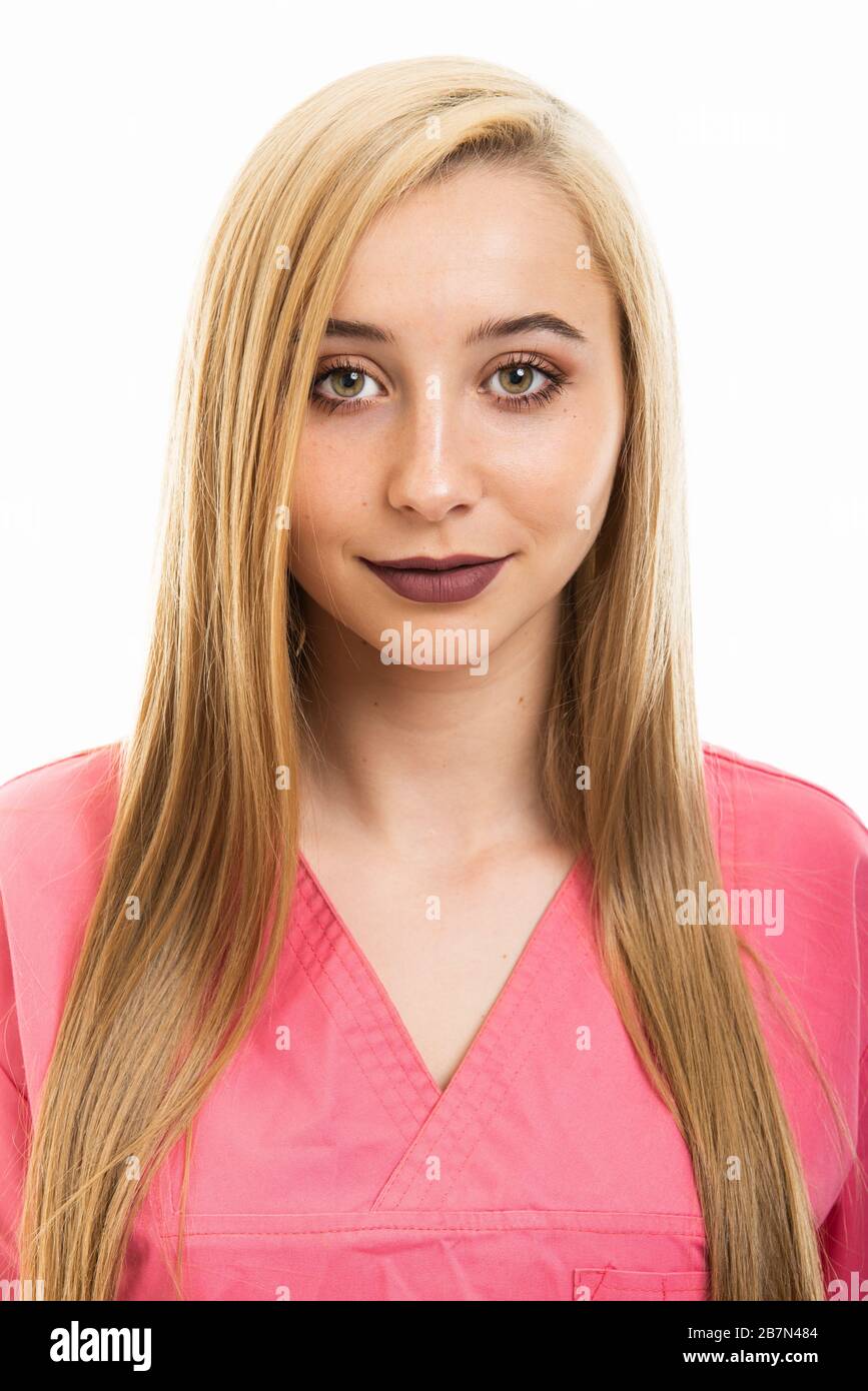 Portrait of cute young female nurse wearing scrubs smiling isolated on ...