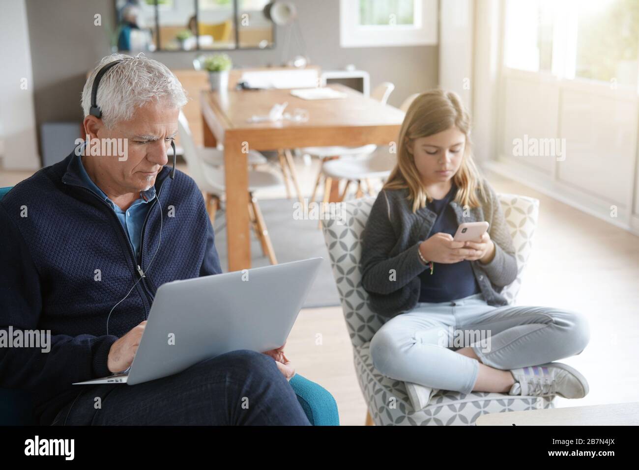 Father and school-girl working form home, telework and e-learning Stock ...