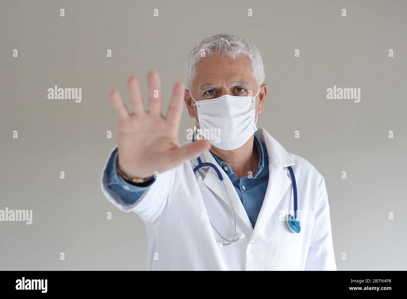 Doctor with protection mask stopping virus spreading, isolated Stock ...