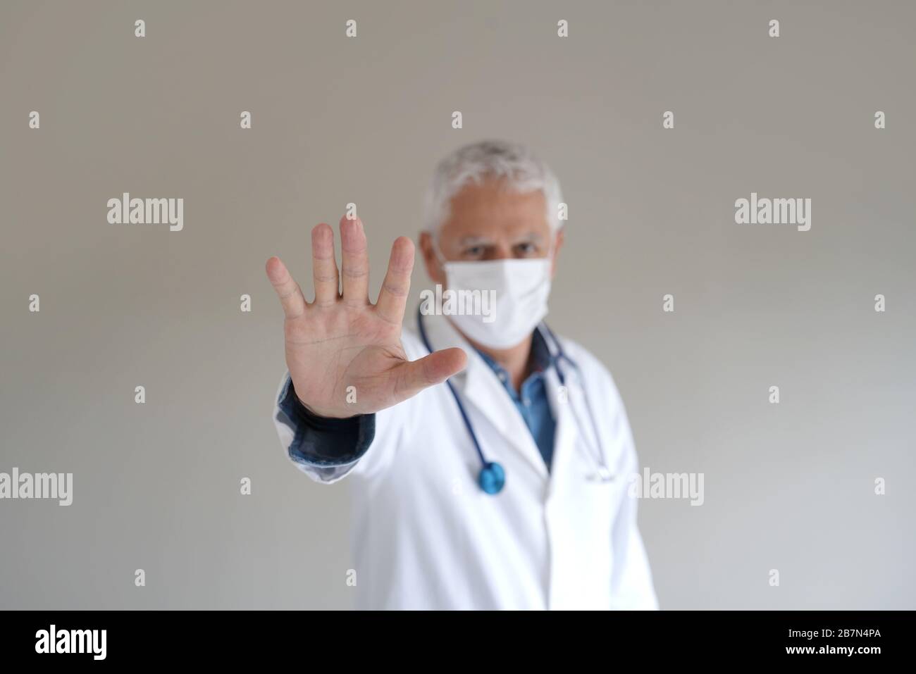 Doctor with protection mask stopping virus spreading, isolated Stock ...