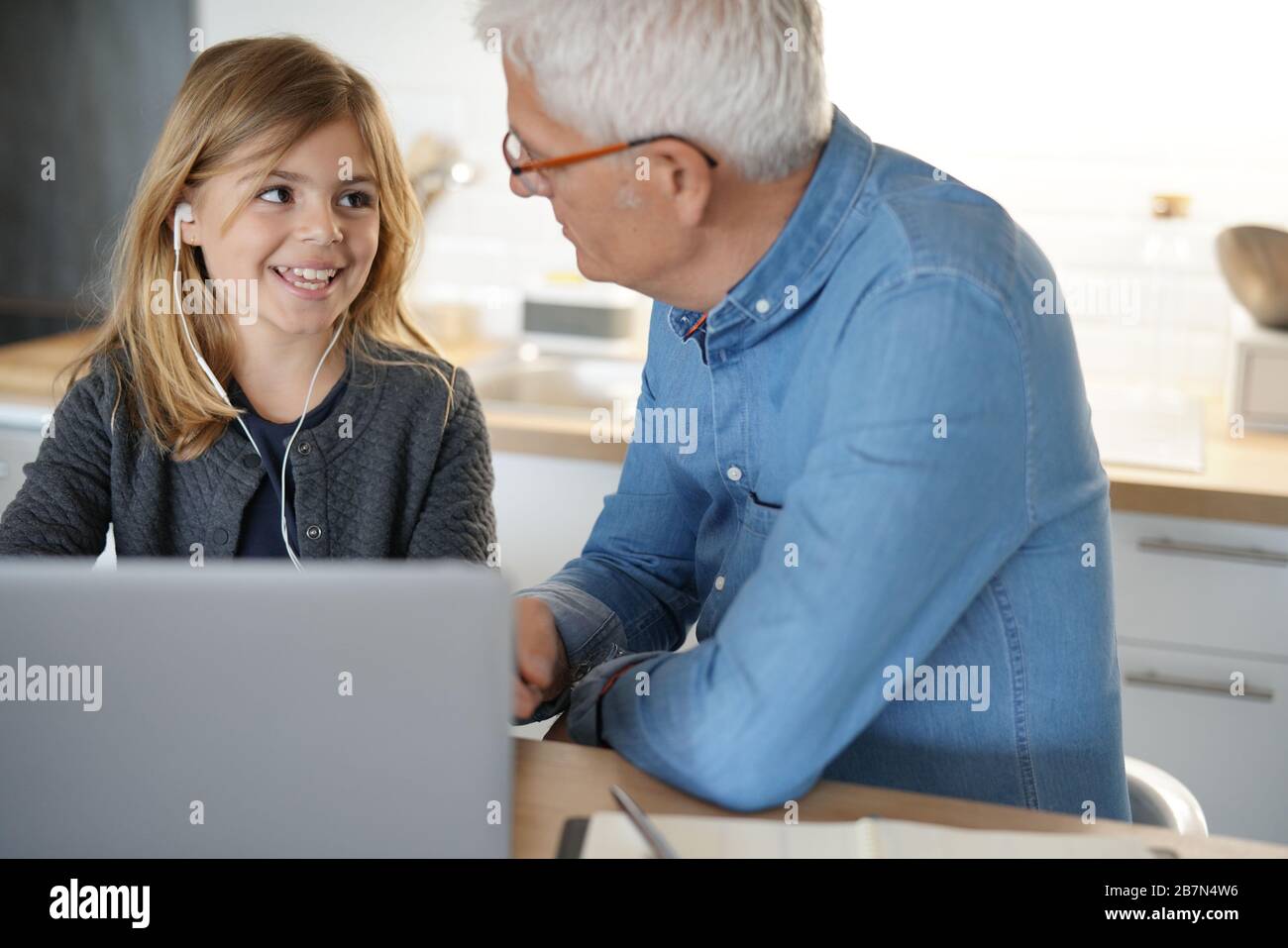 Father and child at home doing online school teaching class Stock Photo ...