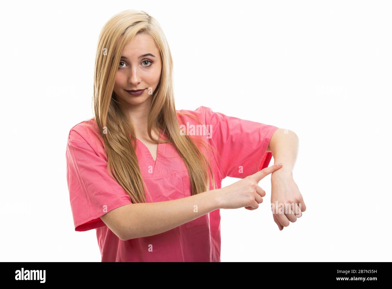 Portrait of female nurse wearing scrubs making late gesture isolated on ...