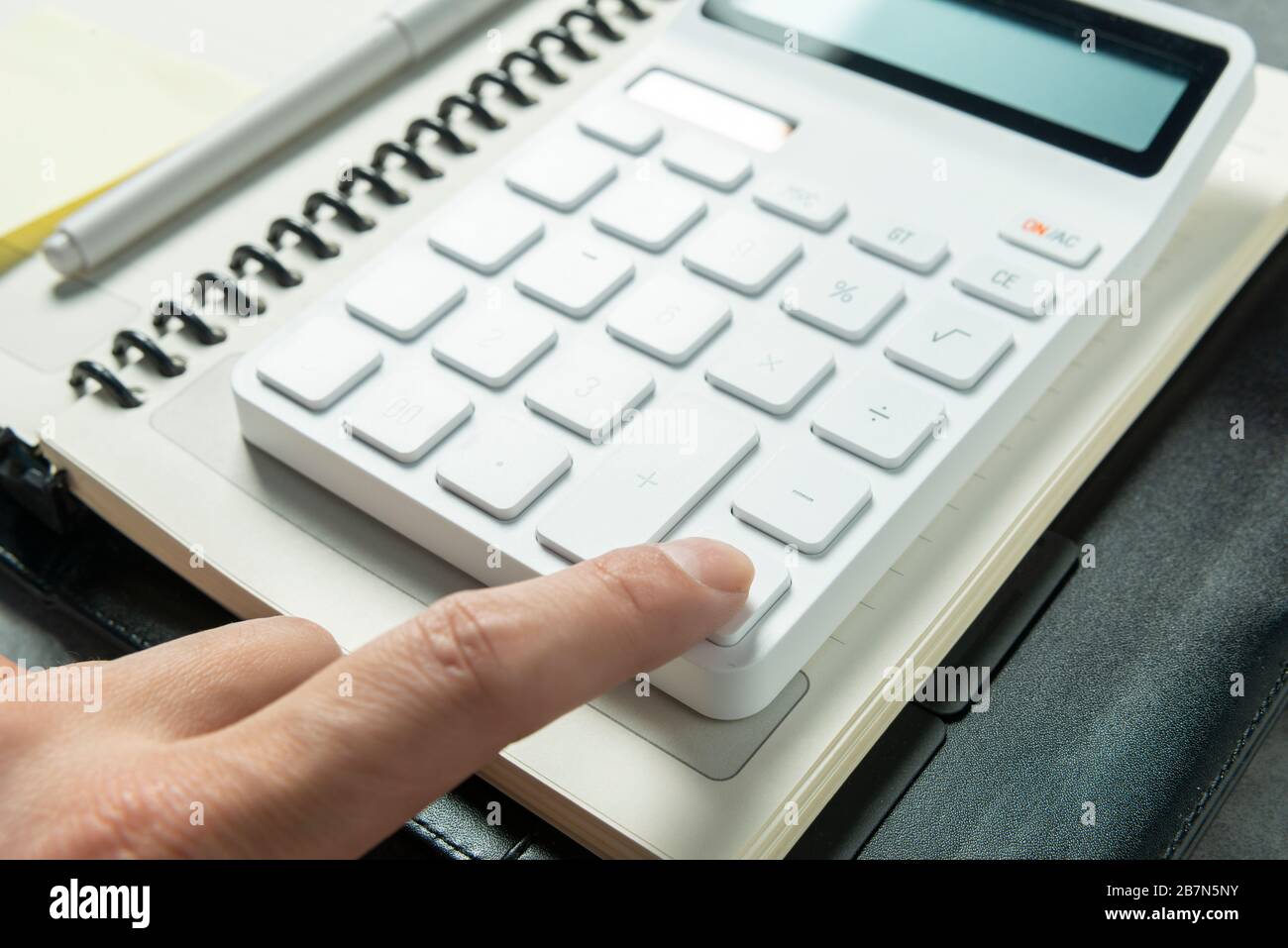 A calculator on the table.The Chinese meaning is: financial resources ...