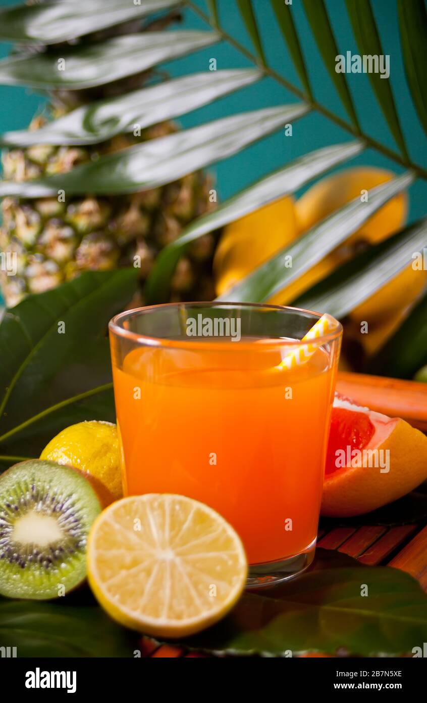 Glass of tropical exotic multifruit juice with pineapple, fruits and ...