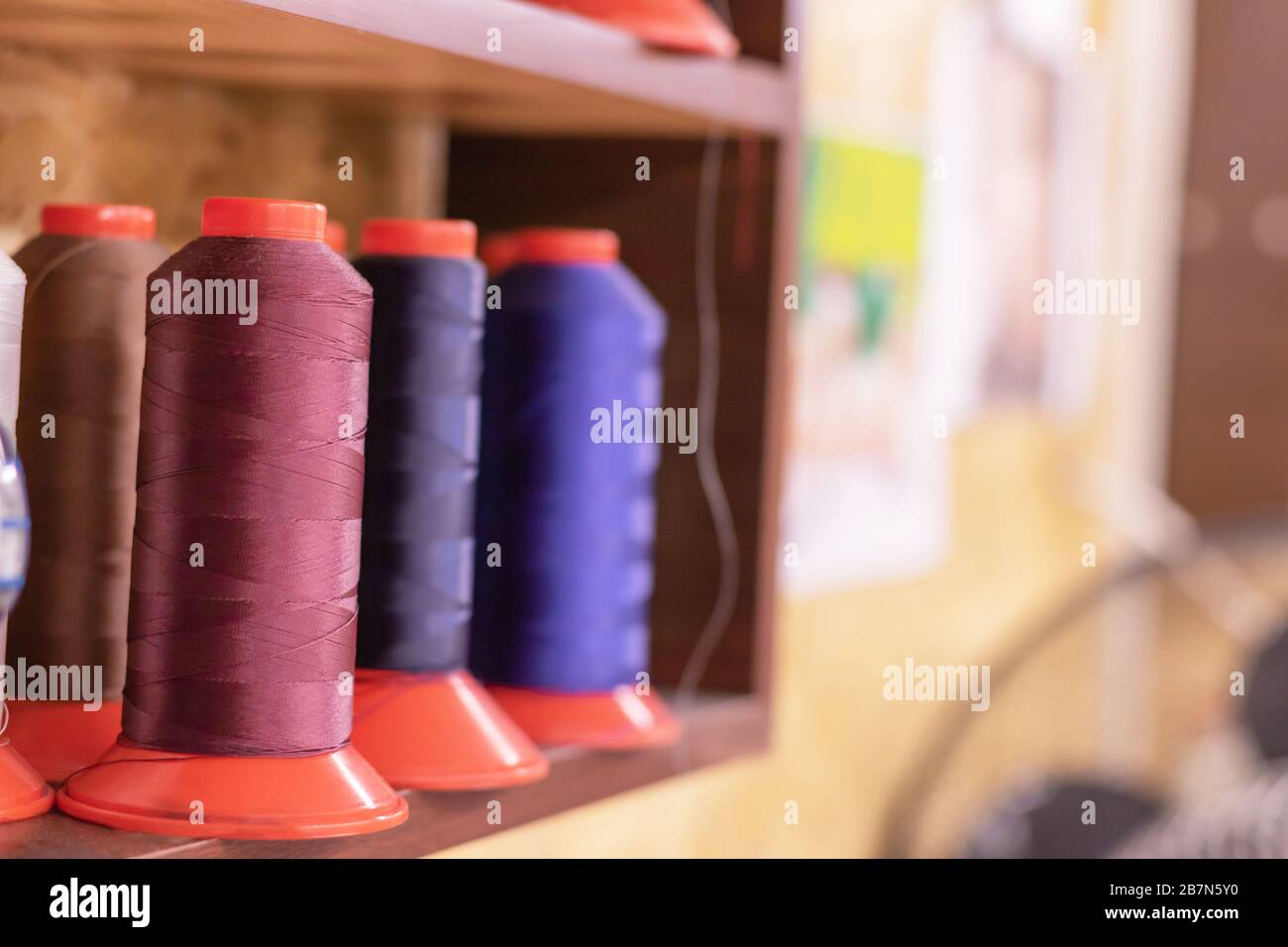 Colorful thread spools used in fabric and textile industry for shoes ...