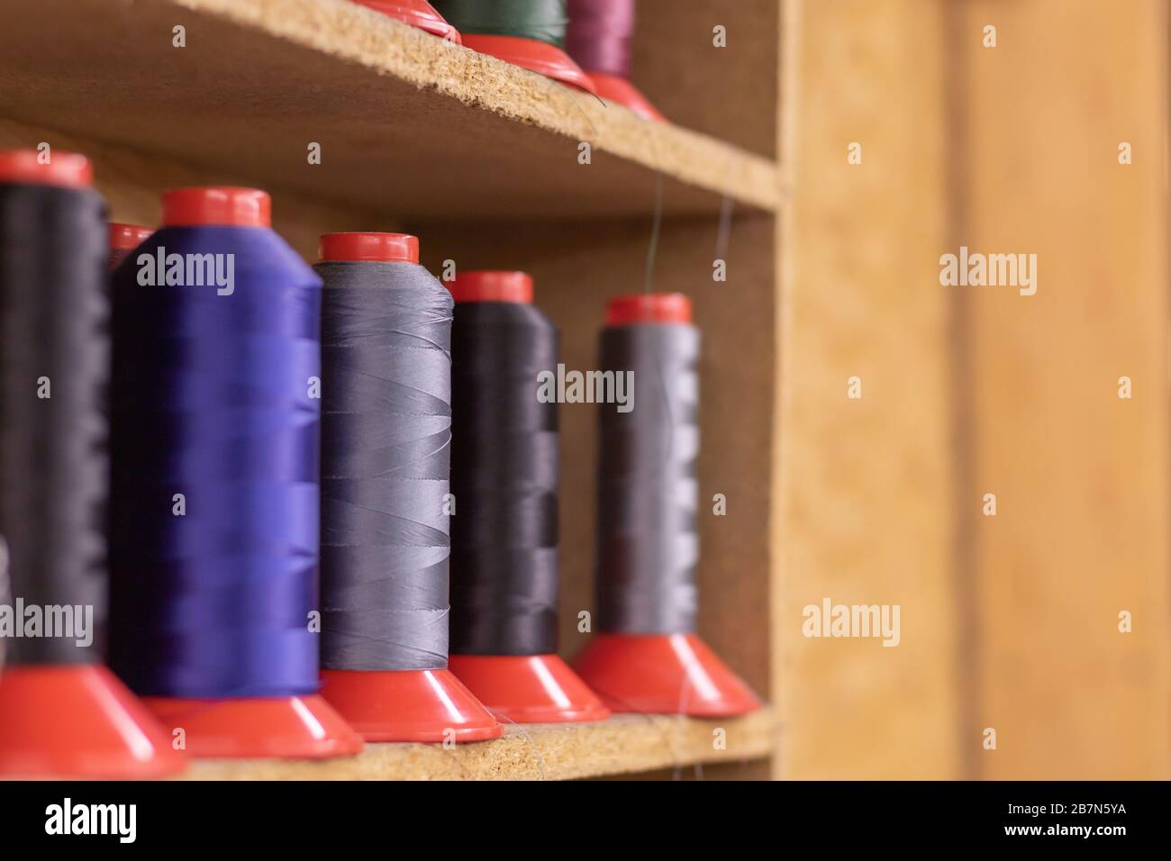 Colorful thread spools used in fabric and textile industry for shoes ...