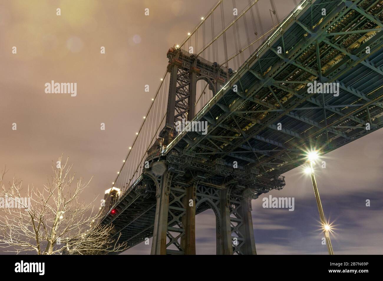Creepy and dramatic view of Manhattan Bridge at night. Dumbo park ...