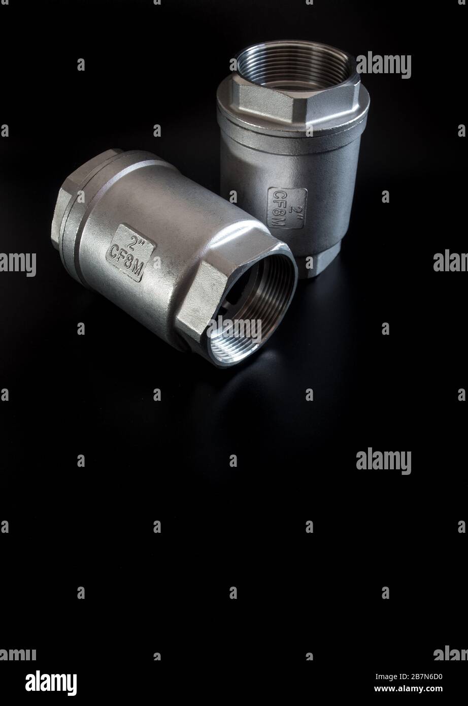 Cast stainless steel check valve 2 inch on black background Stock Photo ...