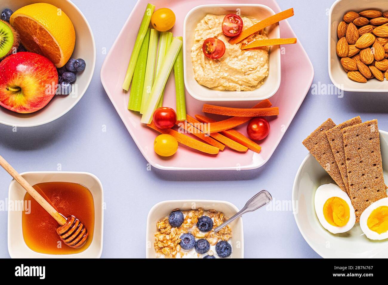 Healthy snack on a pastel background, top view Stock Photo - Alamy