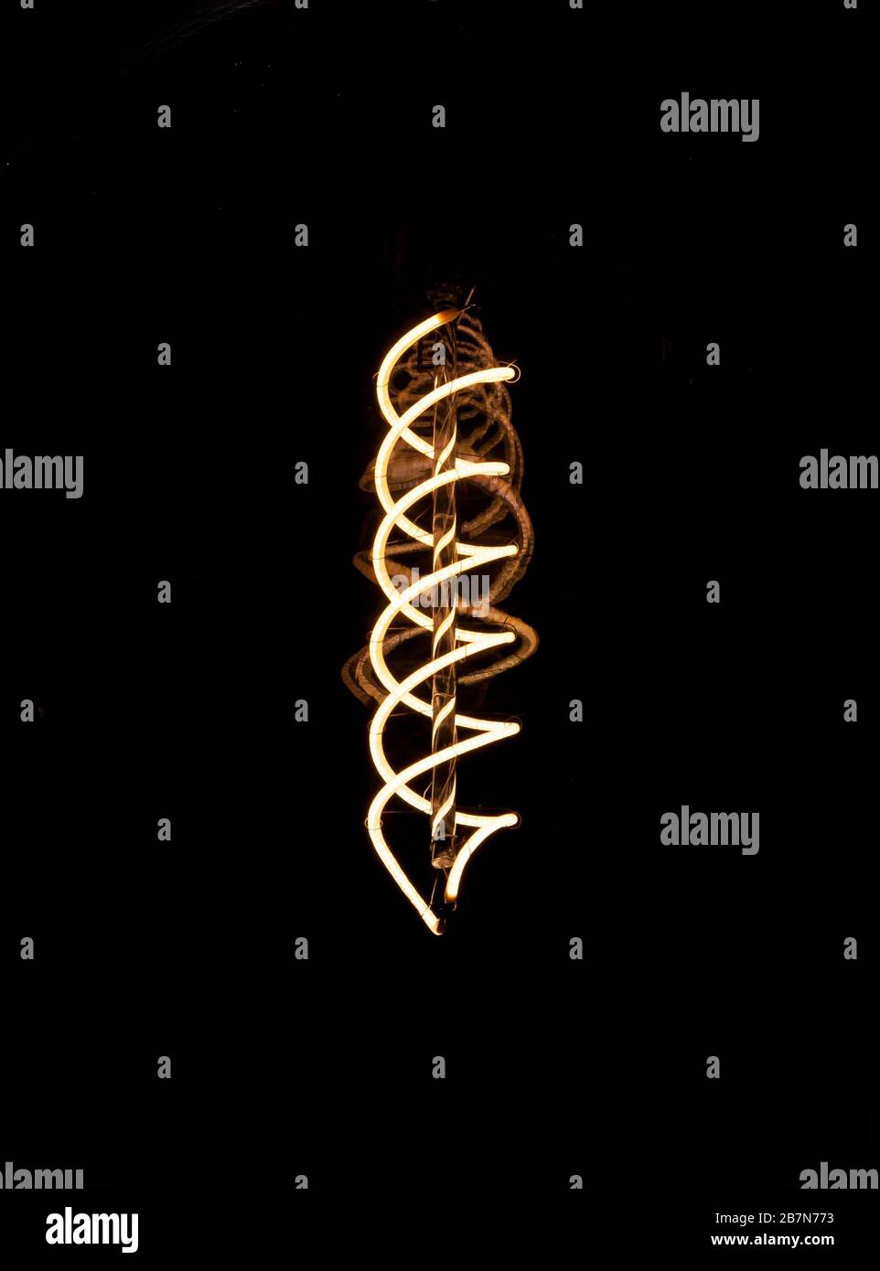 Luminous thread of a retro Edison lamp on a dark background Stock Photo ...