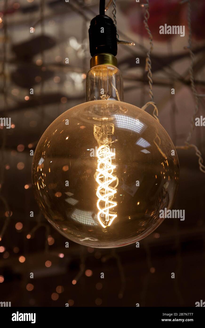 Luminous thread of a retro Edison lamp on a dark background Stock Photo ...